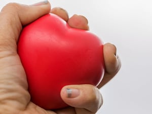 hand squeezing heart